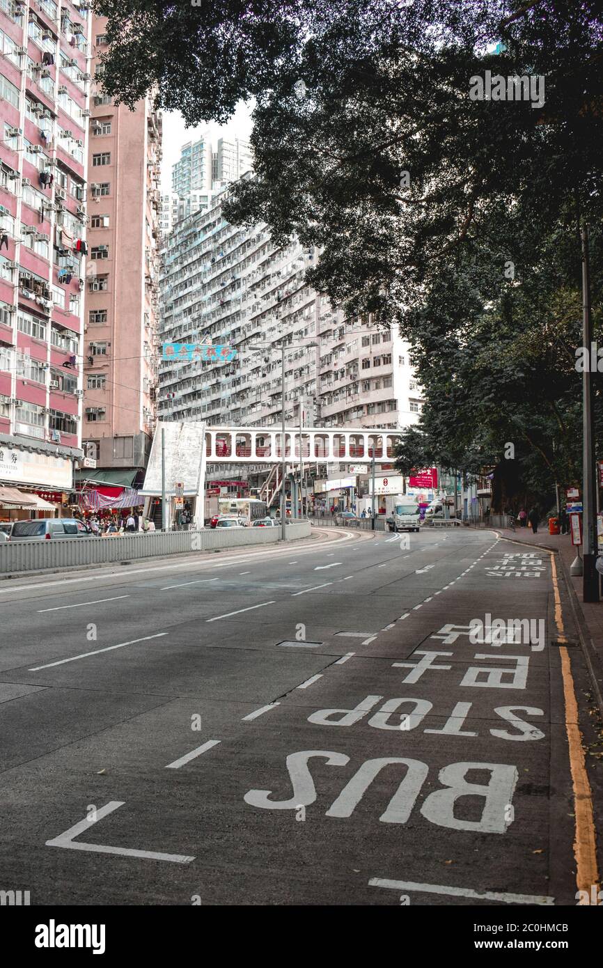 Bus stop on an empty street in Hong Kong with cluttered residential ...