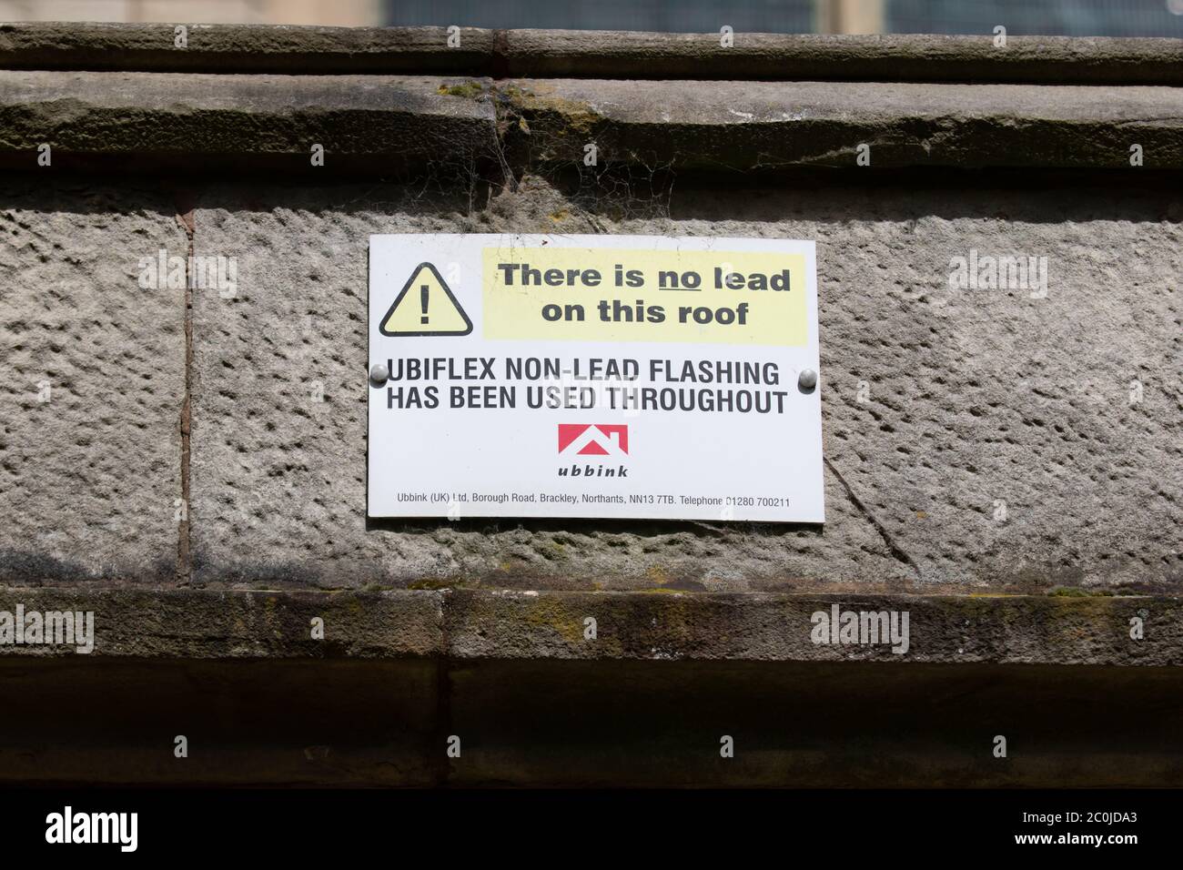 Sign informing that non-lead flashing has been used on church roof to ...