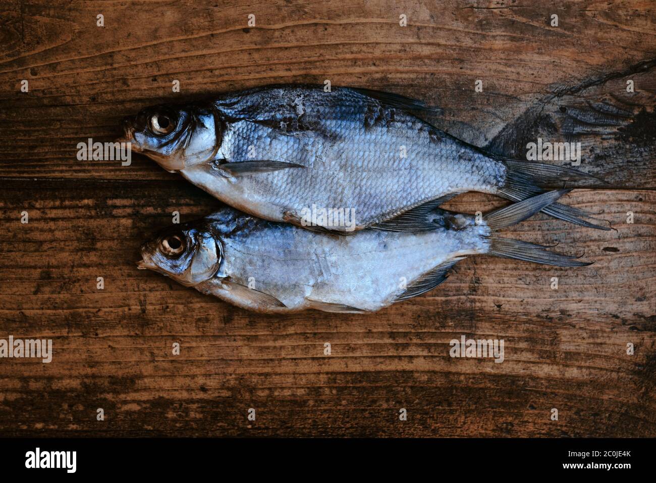 Salty dry river fish on a dark wooden background. Dry fish in the ...