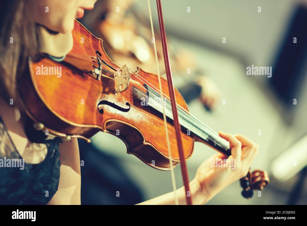 Symphony orchestra on stage, hands playing violin Stock Photo - Alamy