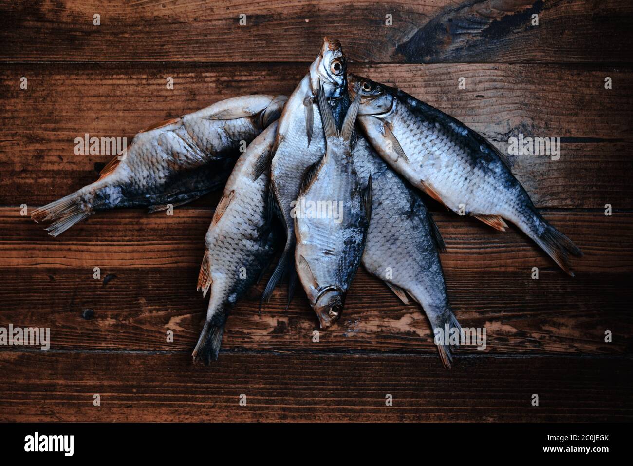 Salty dry river fish on a dark wooden background. Dry fish in the ...