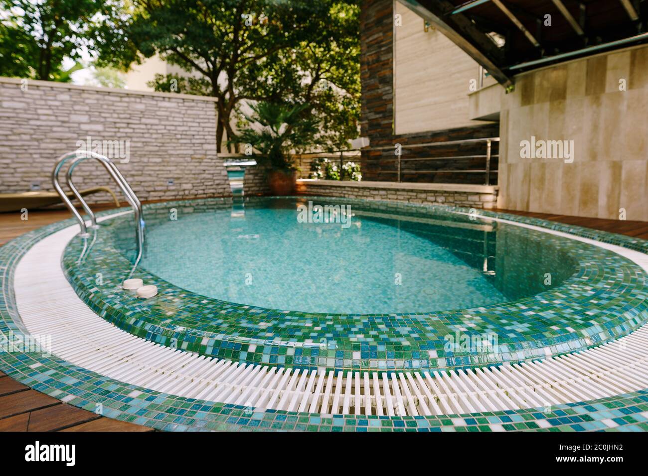 The oval turquoise swimming pool at the villa Stock Photo - Alamy
