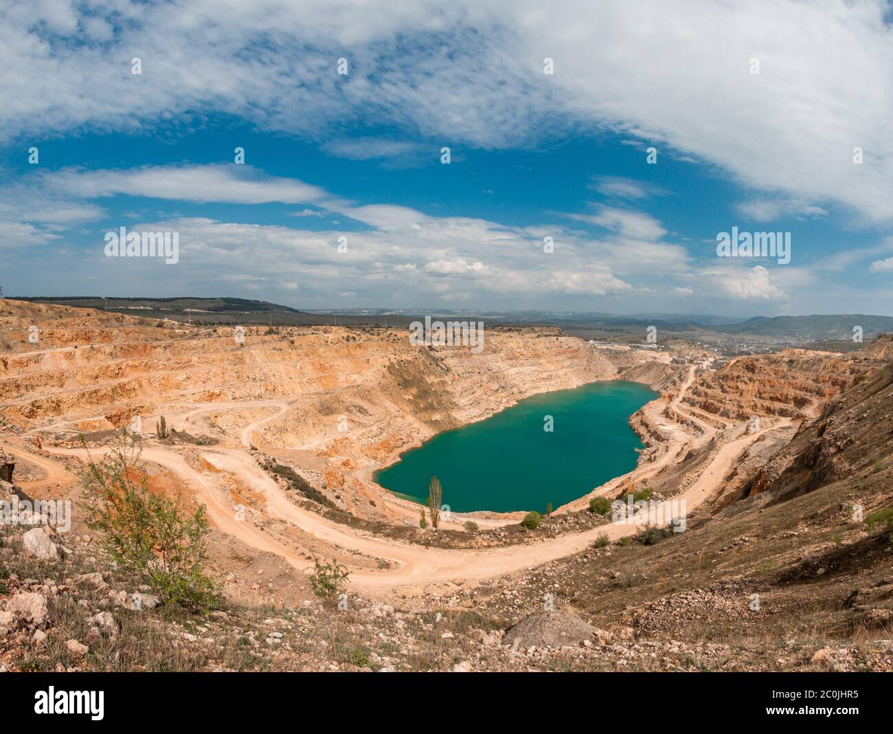 Emerald green lake in flooded opencast mine, open pit. Oval lake in ...