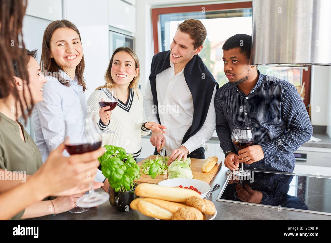 Students friends talking in shared kitchen preparing to eat together ...