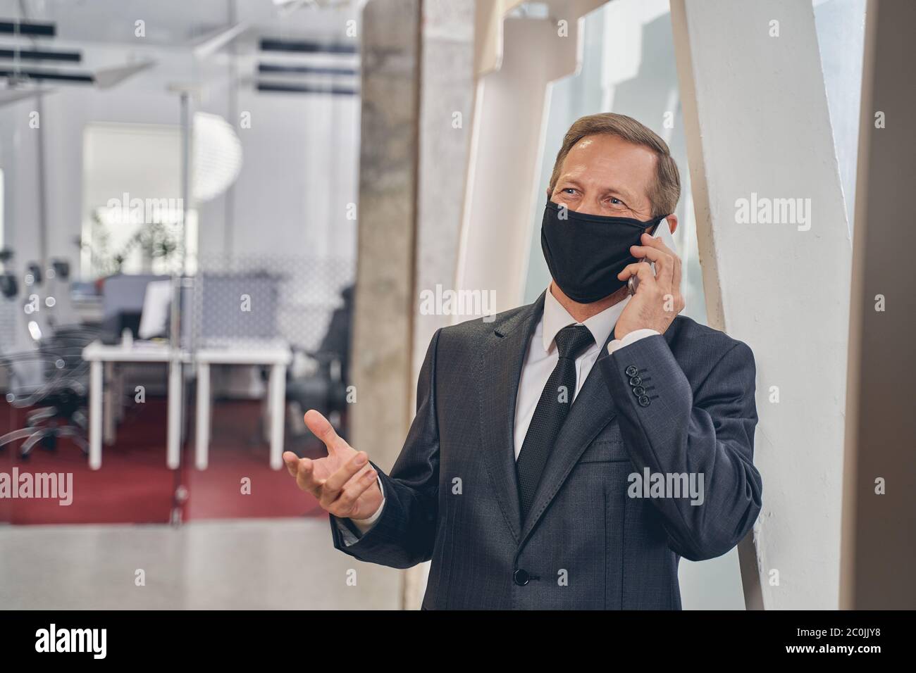 Kind male person talking per telephone at work Stock Photo - Alamy