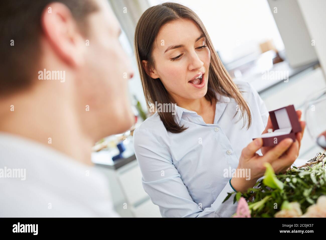 Marriage proposal with wedding ring as a surprise for young woman from ...