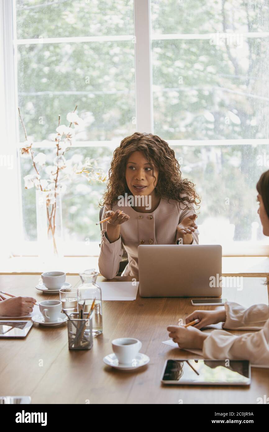 Leader. Young business woman in modern office with team. Creative ...