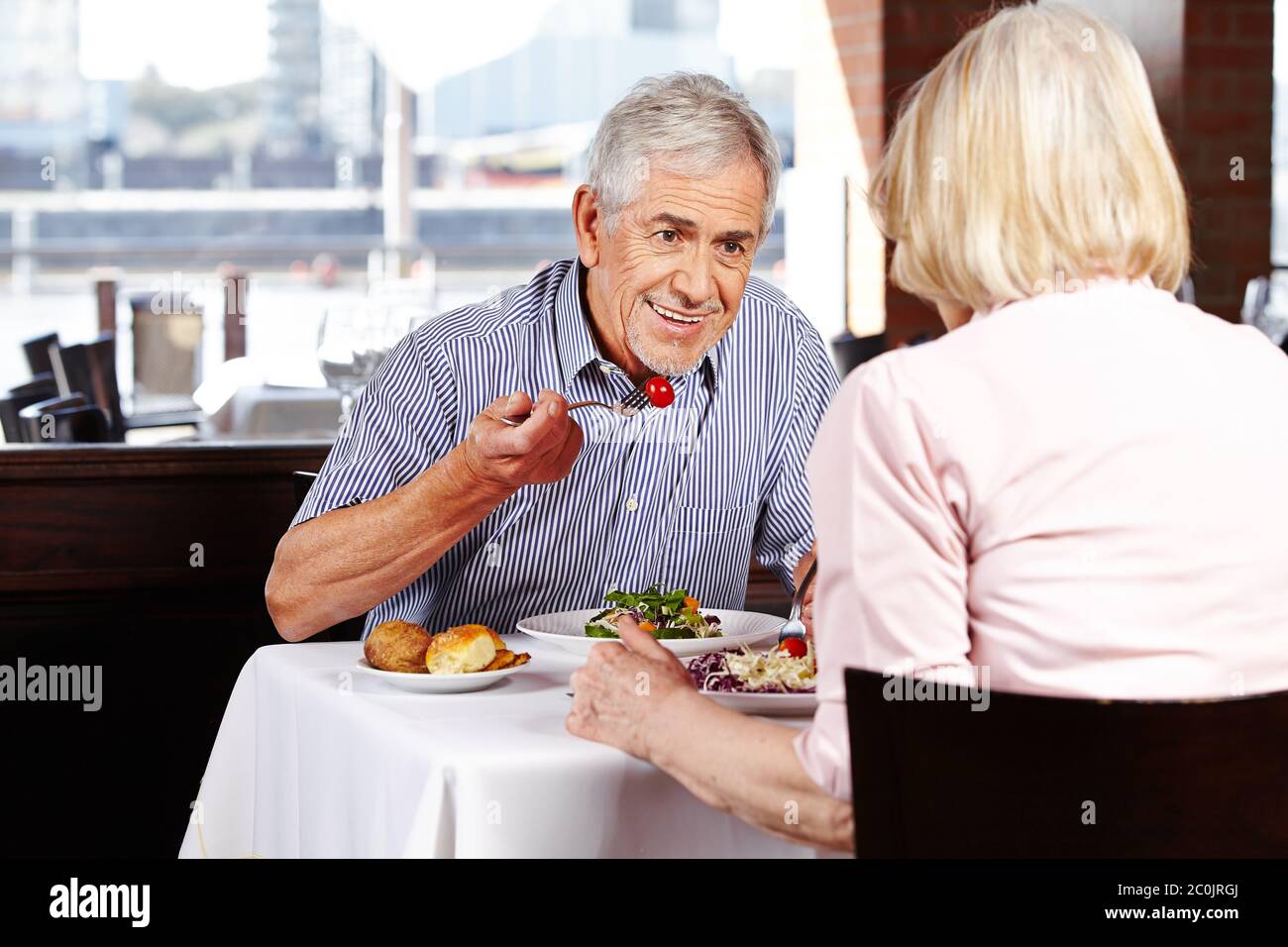 Two seniors talk over dinner in a fine restaurant Stock Photo - Alamy