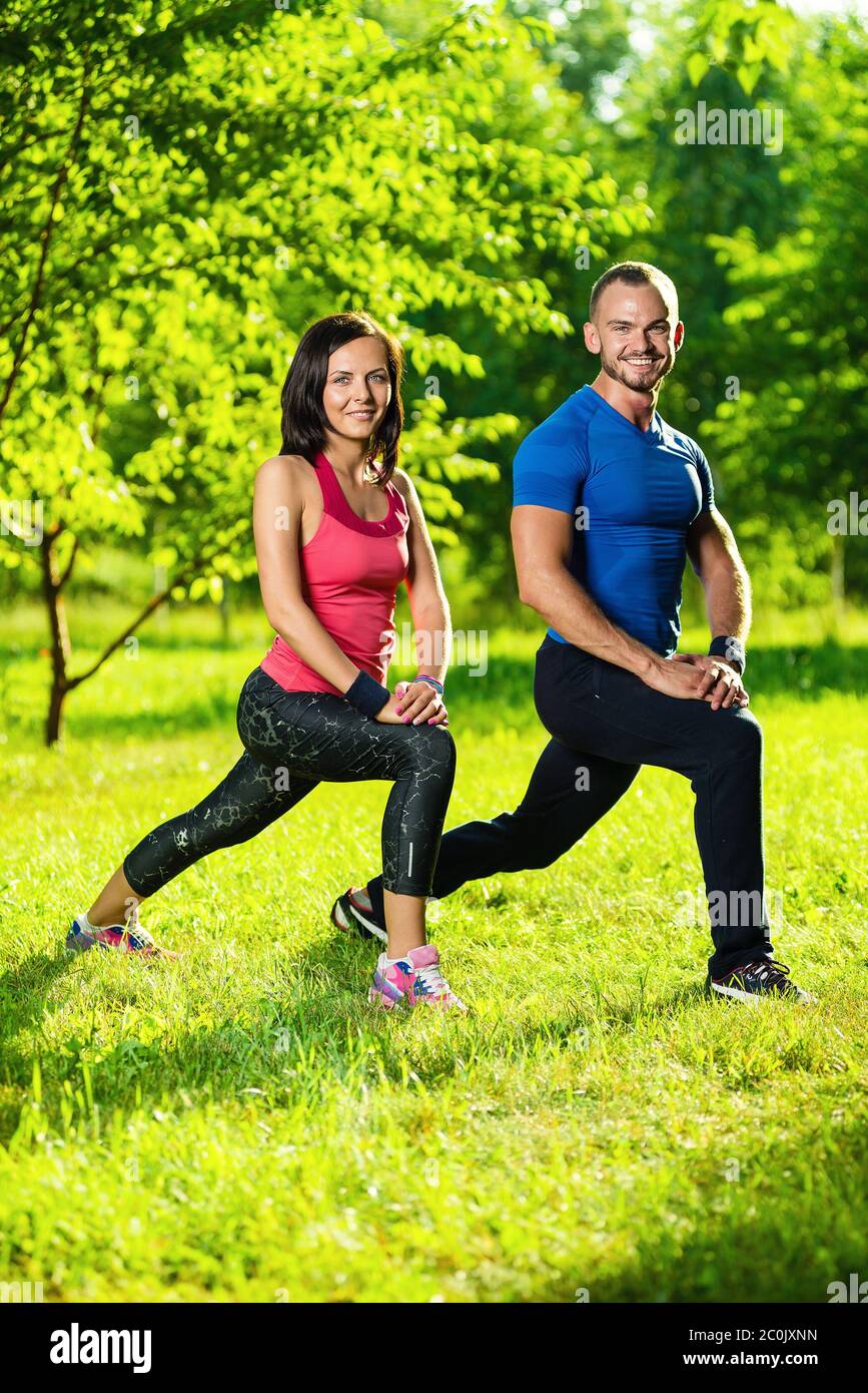 Man and woman doing stretching exercises Stock Photo - Alamy