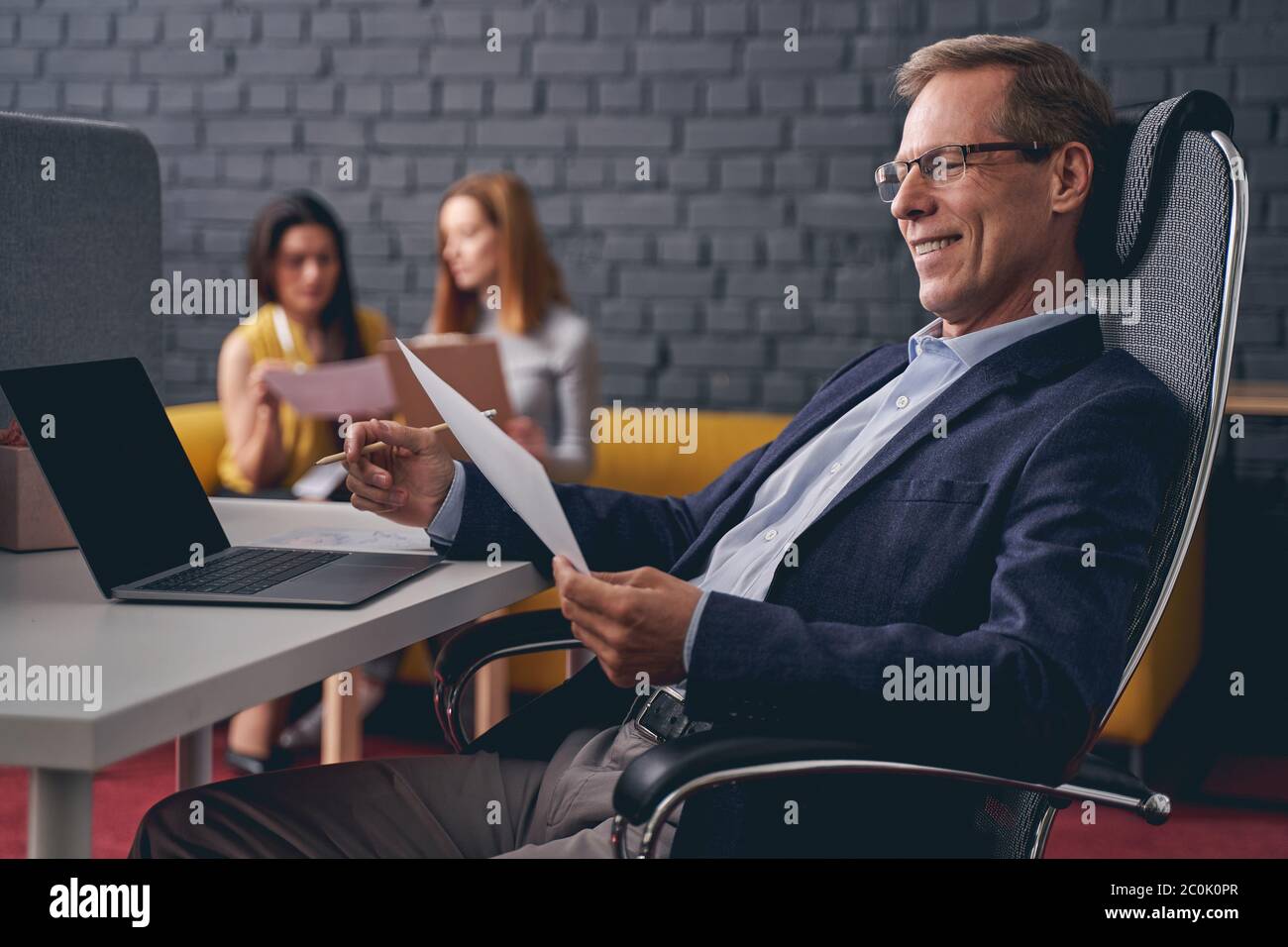 Positive delighted male person working with pleasure Stock Photo - Alamy