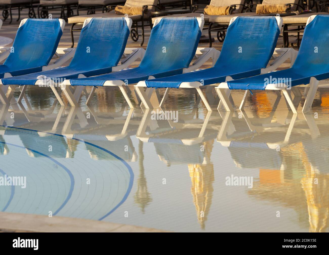 Empty beach chairs near pool Stock Photo - Alamy
