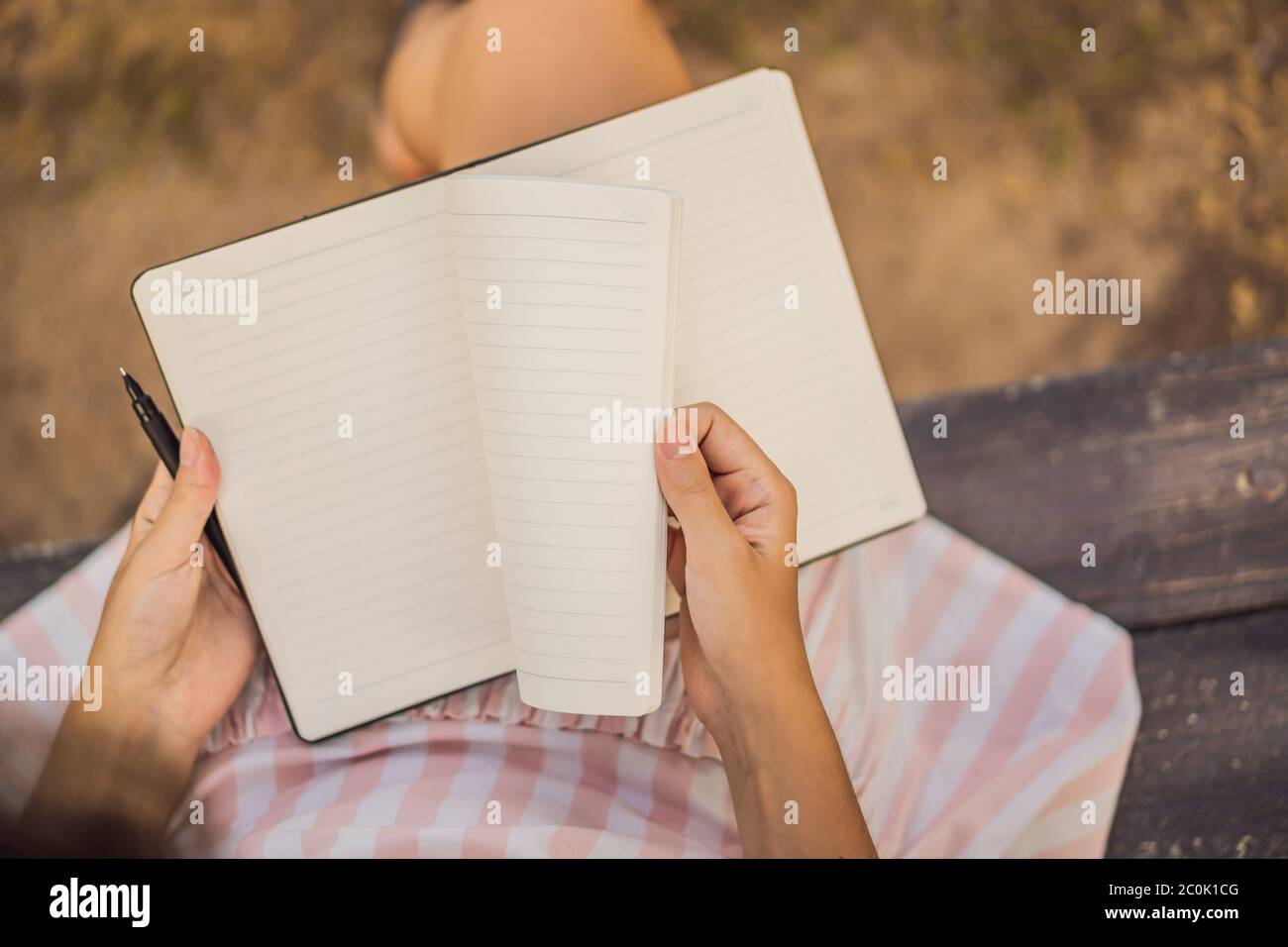 MOCKUP, SCENE CREATOR Women's hands in a tropical background holding a ...