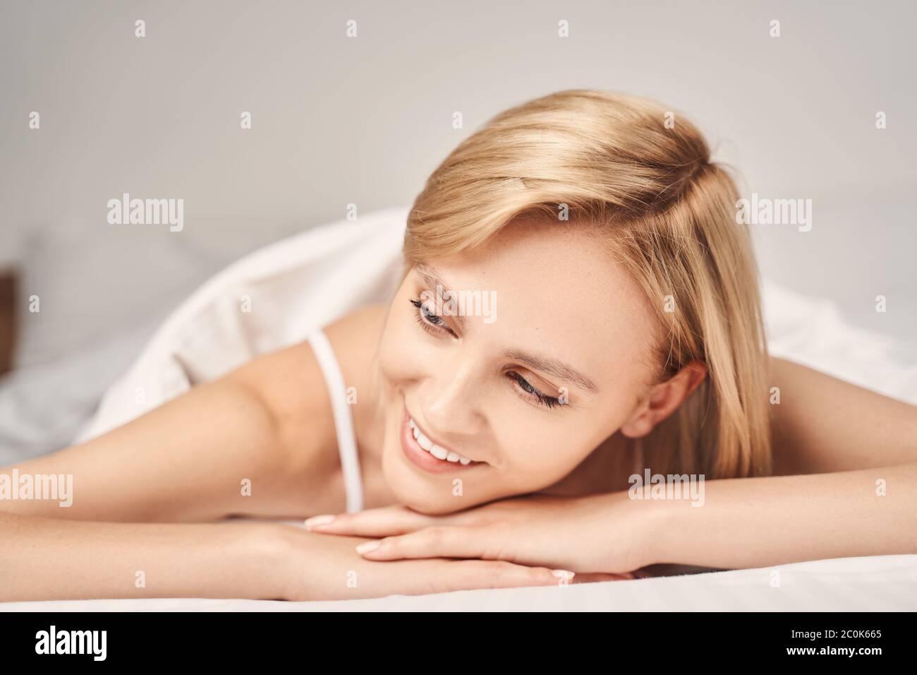 Woman whiling away the time in bed Stock Photo - Alamy