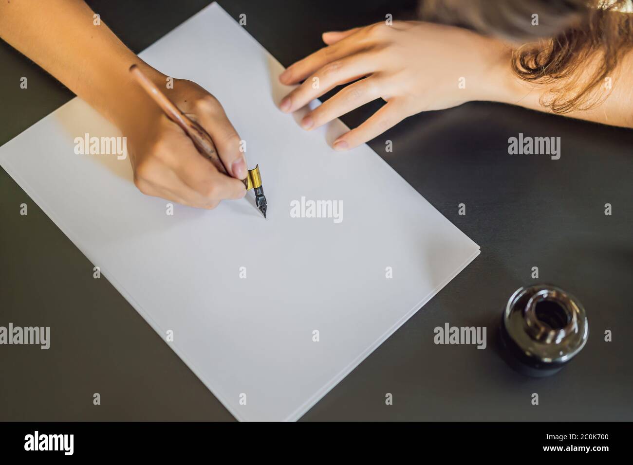 MOCKUP, SCENE CREATOR Calligrapher Young Woman writes phrase on white ...