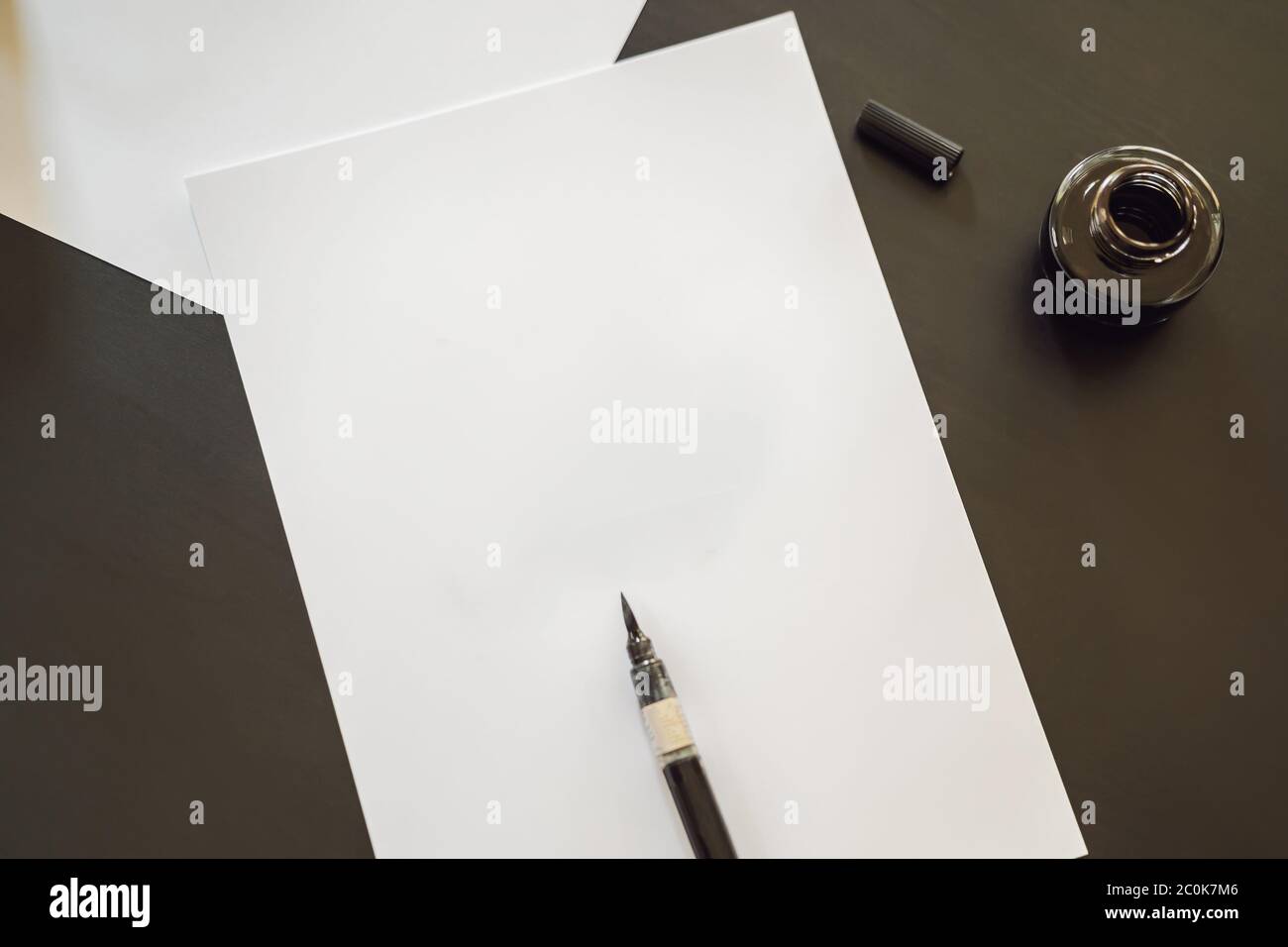 MOCKUP, SCENE CREATOR Calligrapher Young Woman writes phrase on white ...