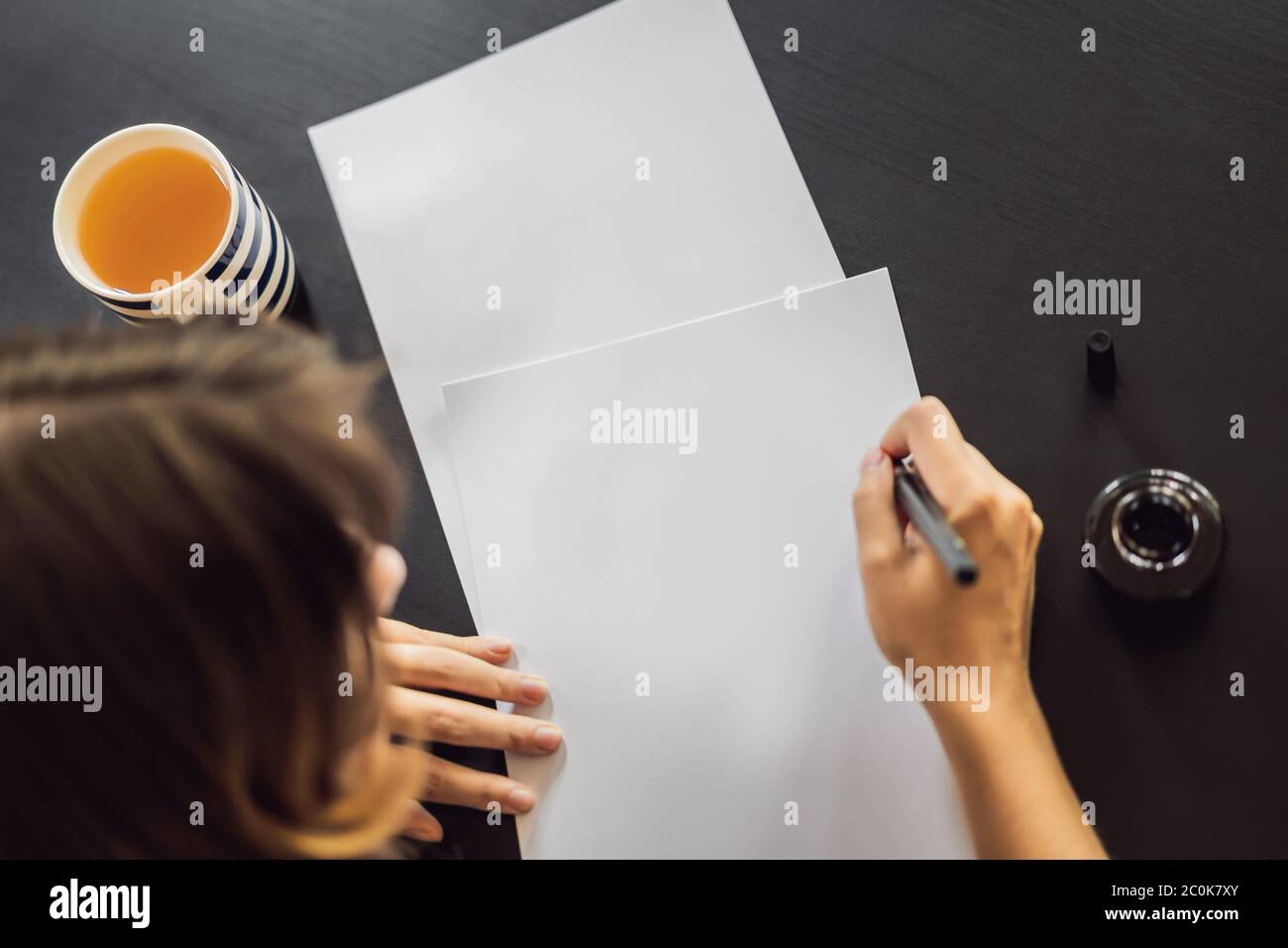 MOCKUP, SCENE CREATOR Calligrapher Young Woman writes phrase on white ...