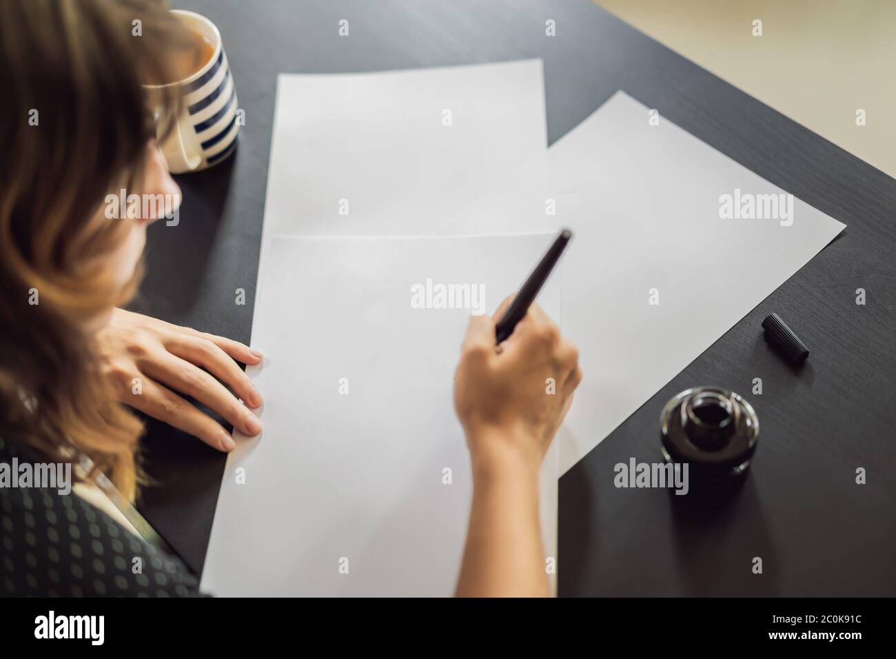 MOCKUP, SCENE CREATOR Calligrapher Young Woman writes phrase on white ...