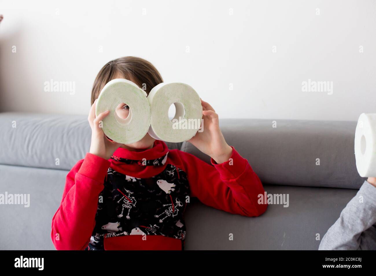 Child, playing with toilet paper ato home Stock Photo - Alamy