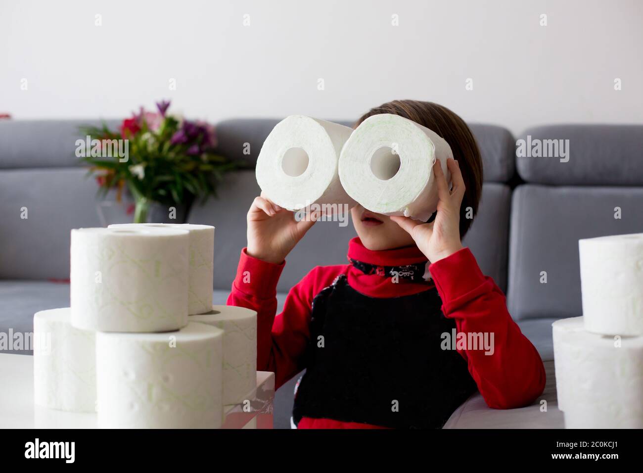 Child, playing with toilet paper ato home Stock Photo - Alamy