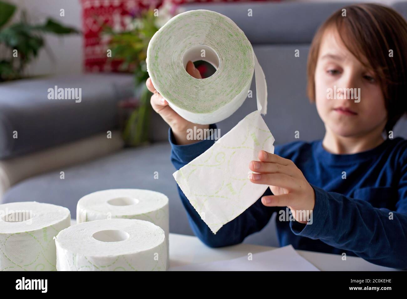 Child, playing with toilet paper ato home Stock Photo - Alamy