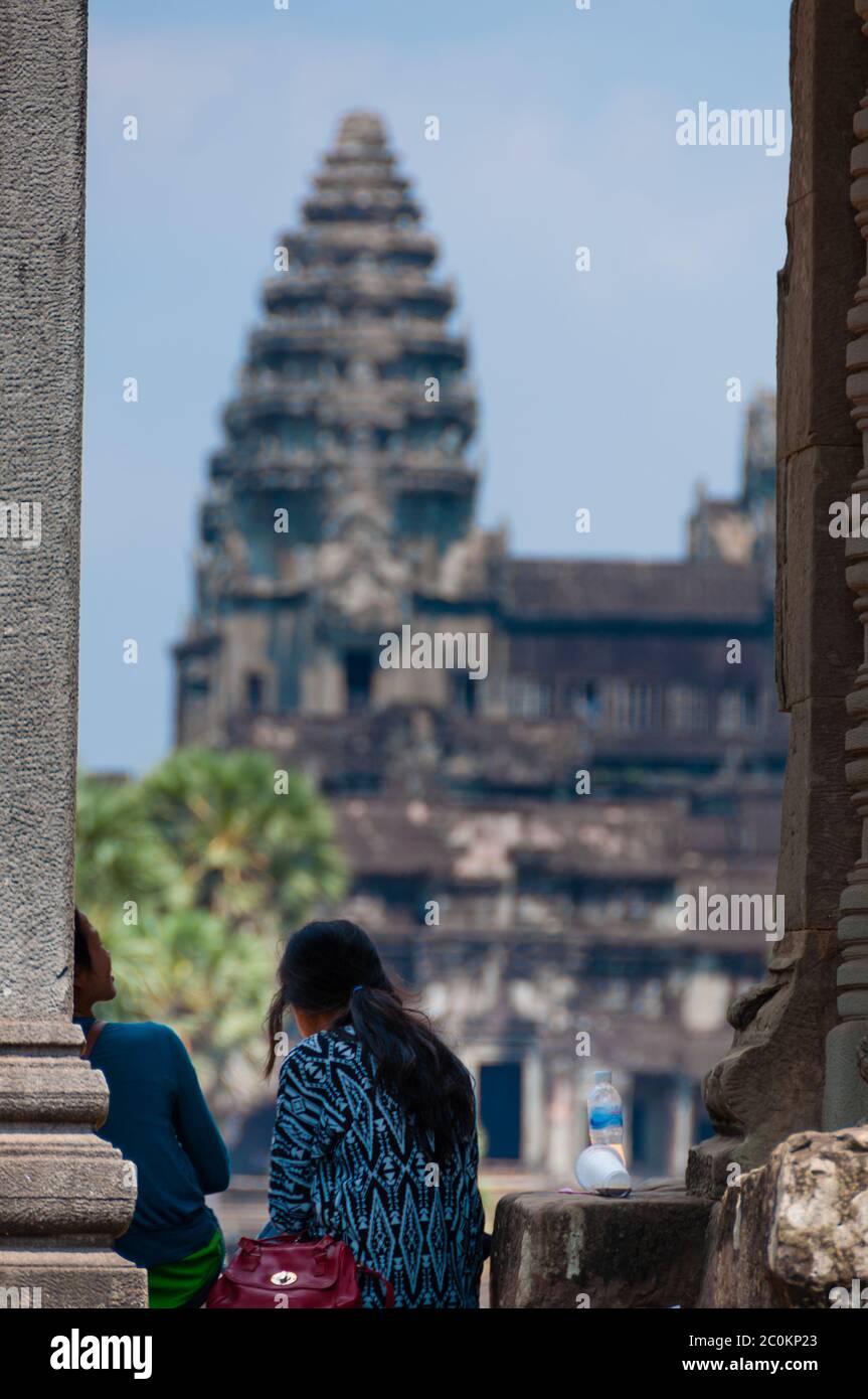 Girl sitting in front of Angkor Wat Stock Photo - Alamy