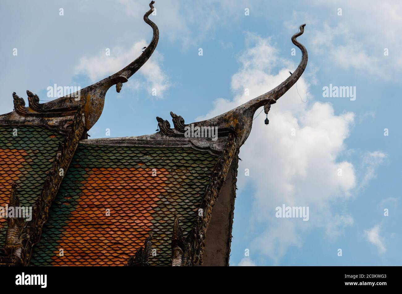 Roof of temple in Laos with blue sky and clouds Stock Photo - Alamy