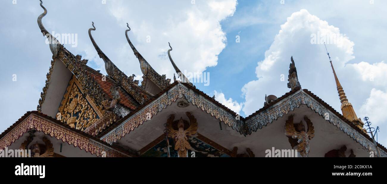 Roof of temple in Laos with blue sky and clouds Stock Photo - Alamy