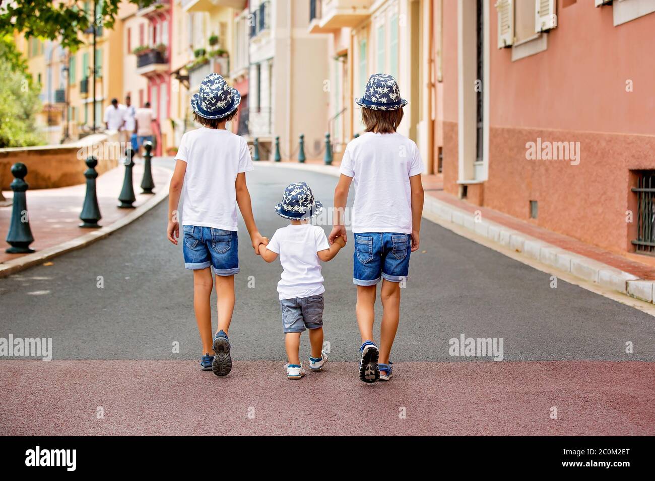 Children walking on a narrow street with houses in Monaco-Ville, Monaco ...