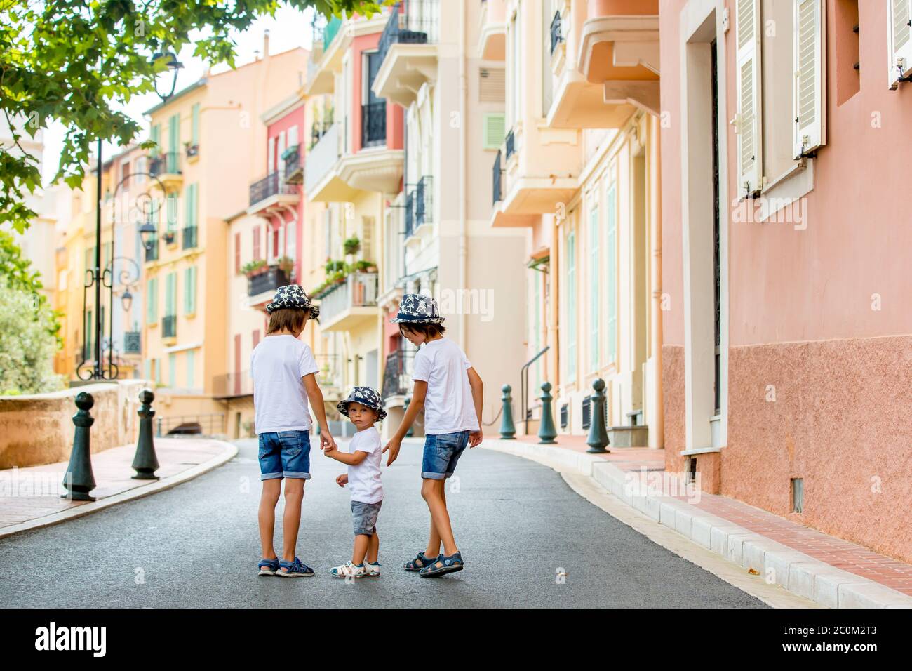 Children walking on a narrow street with houses in Monaco-Ville, Monaco ...