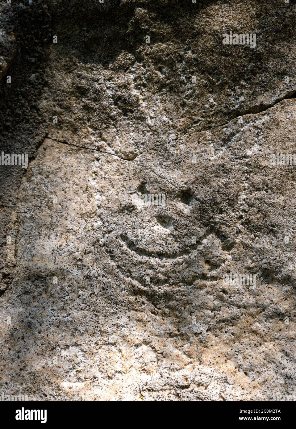 Stone with a painted smile. On the shore, one stone stands out from the ...