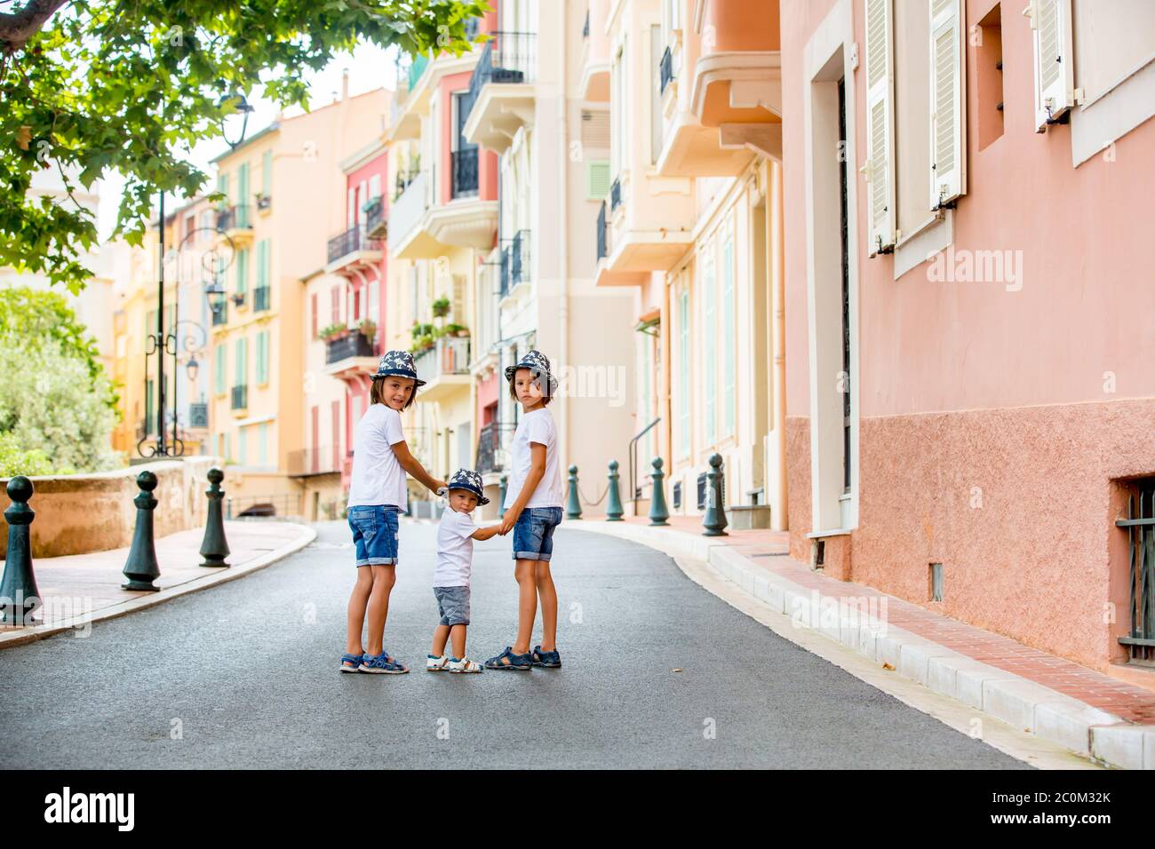 Children walking on a narrow street with houses in Monaco-Ville, Monaco ...