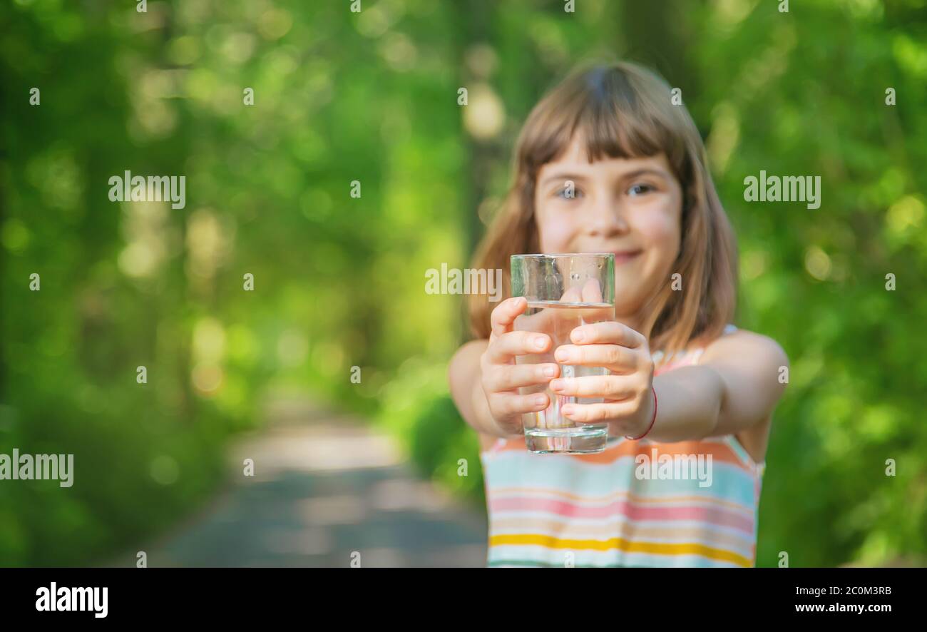 A child drinks water from a glass on the nature. Selective focus. Drink Stock Photo - Alamy