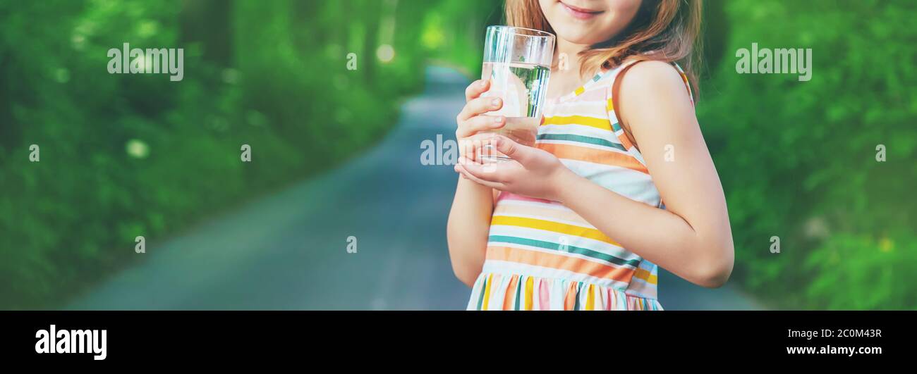 A child drinks water from a glass on the nature. Selective focus. Drink Stock Photo - Alamy