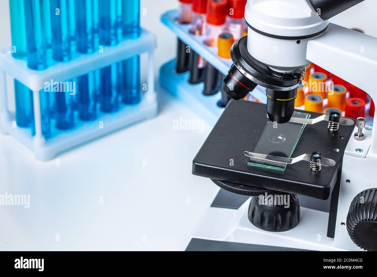 Microscope with test tubes for research close up Stock Photo - Alamy