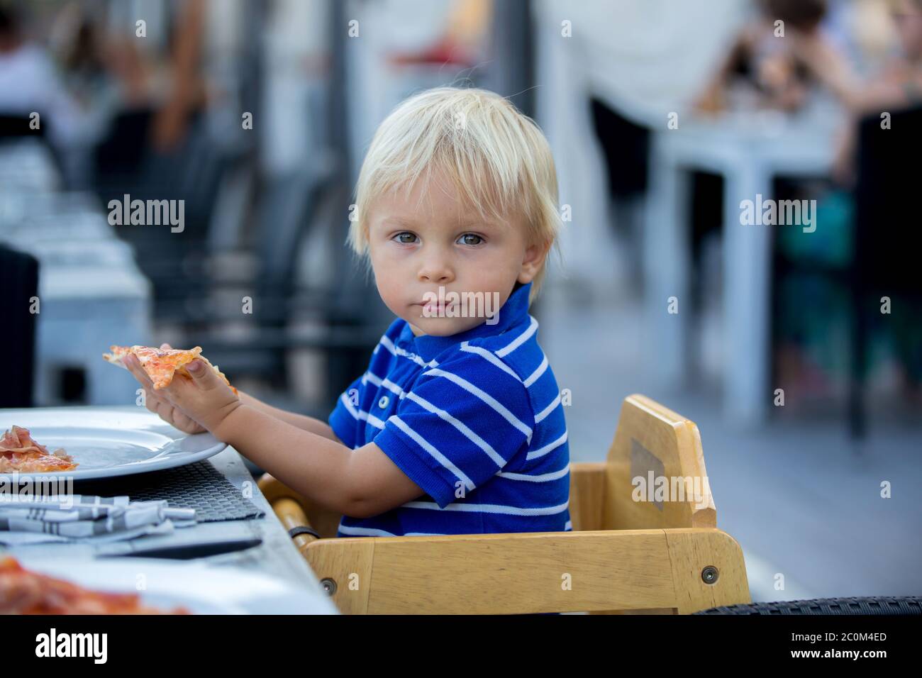 Boy eating slice pizza in hi-res stock photography and images - Alamy