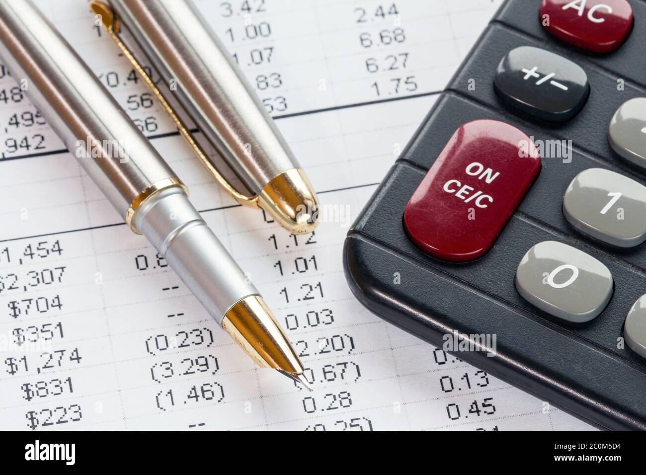 Accounting in process with calculator and pen Stock Photo - Alamy