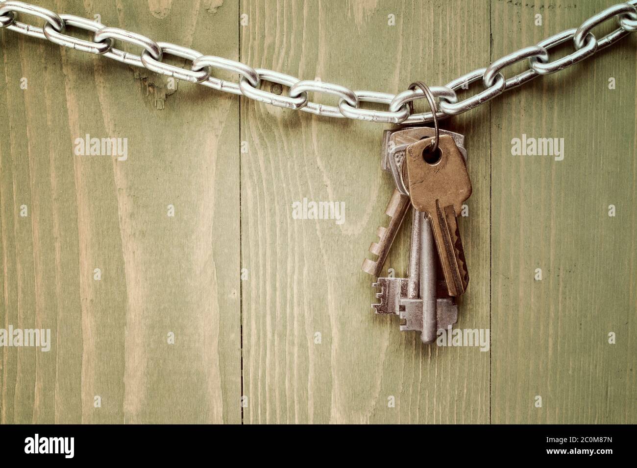 Keys hanging on chain Stock Photo - Alamy