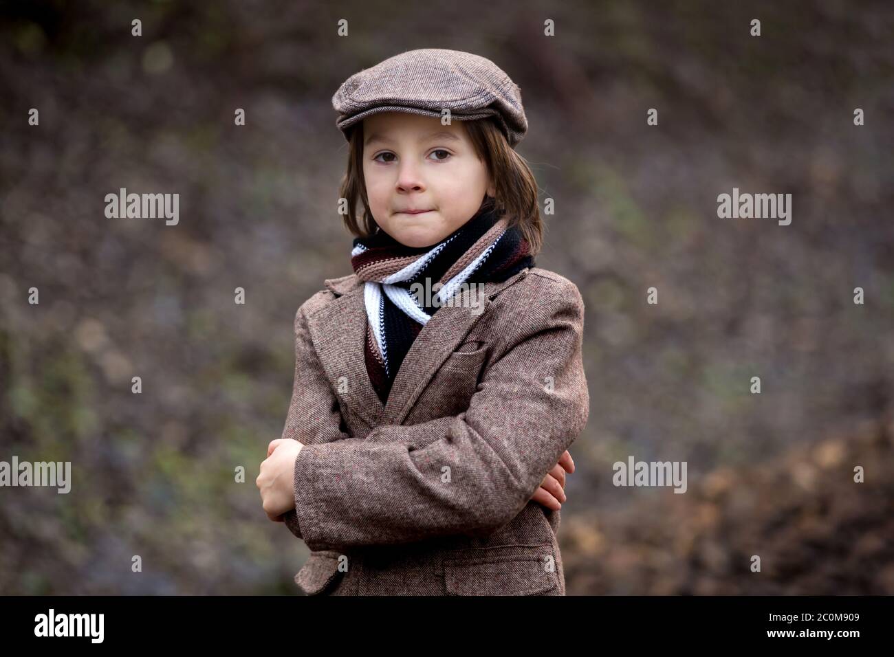 Adorable boy on a railway station, waiting for the train, running and ...
