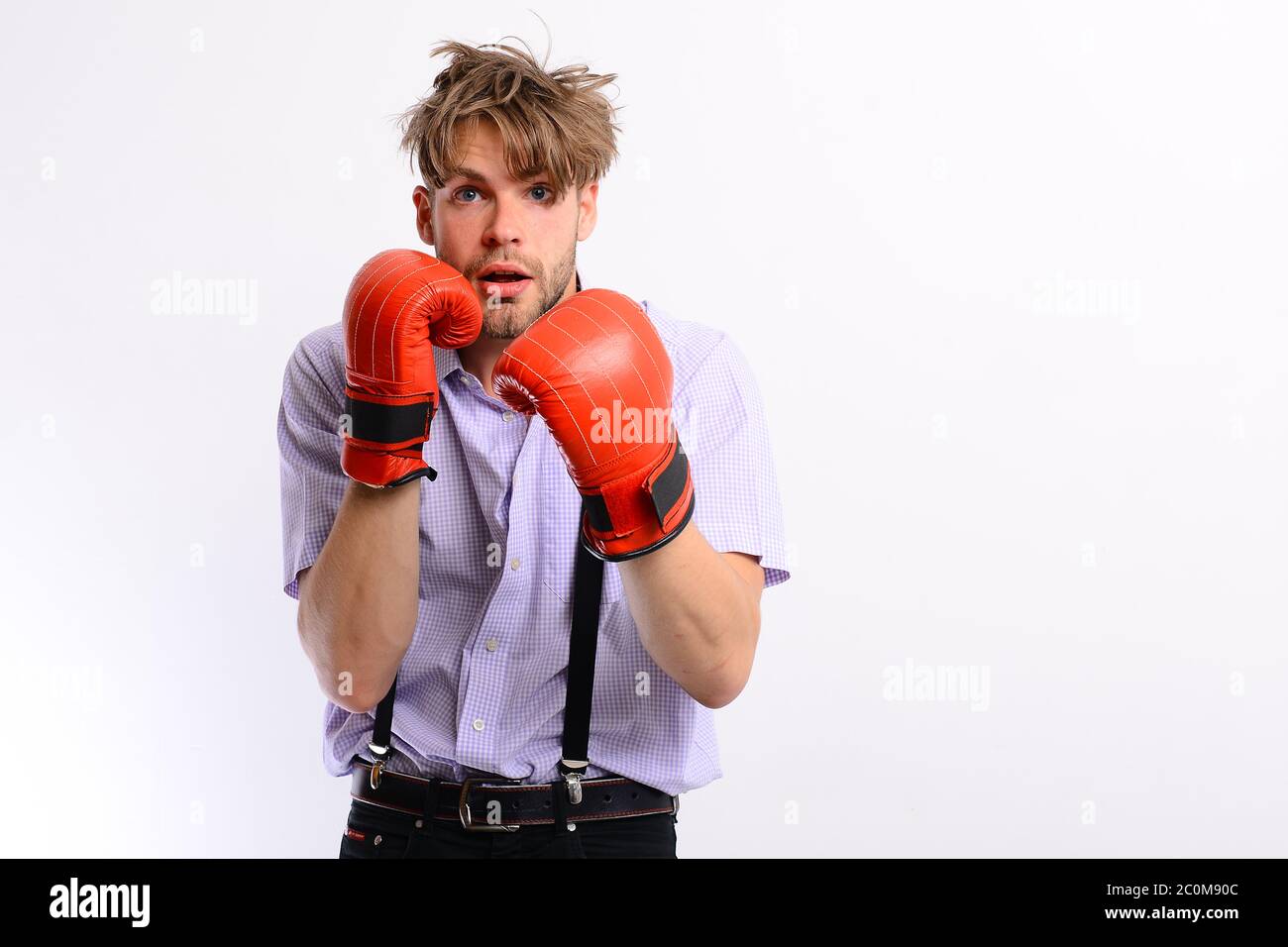 Man with bristle and scared face wears boxing gloves. Weak guy in ...