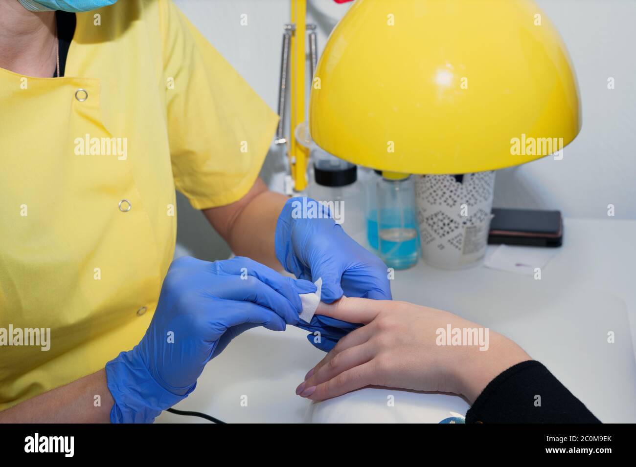 Nail care. Manicure in the salon. The master manicures the girl, beauty ...