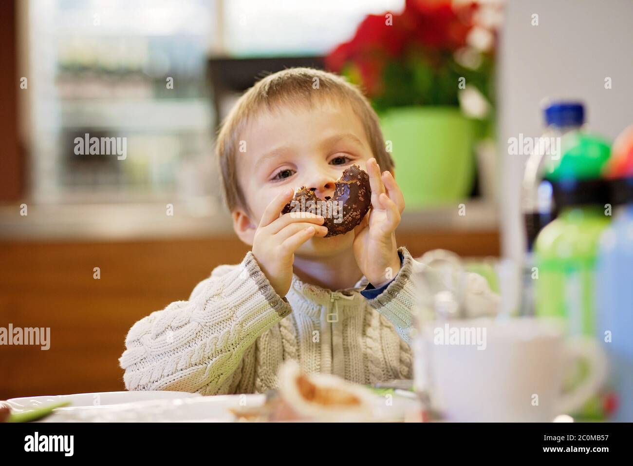 Little toddler boy, eating junk food in restaurant Stock Photo - Alamy