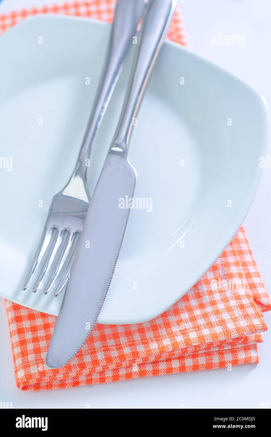 fork and knife on plate Stock Photo - Alamy