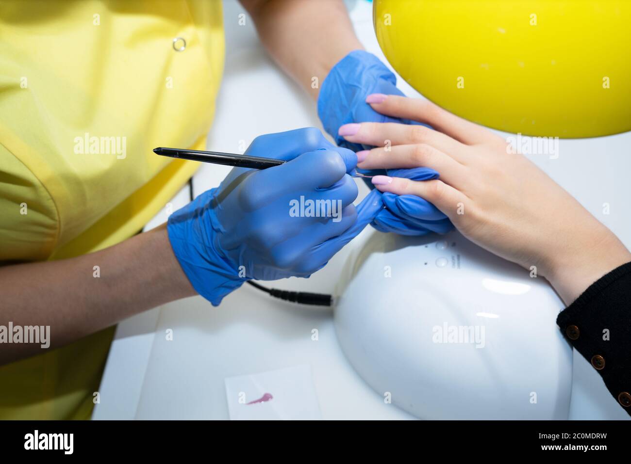 Nail care. Manicure in the salon. The master manicures the girl, beauty ...