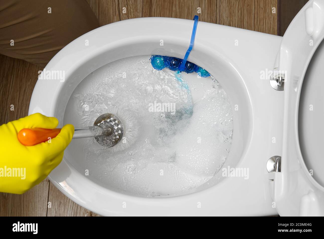 Man cleaning overflowing broken toilet. clogged toilet Stock Photo - Alamy