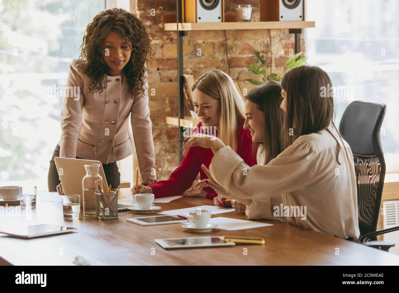Young caucasian business woman in modern office with team. Creative ...