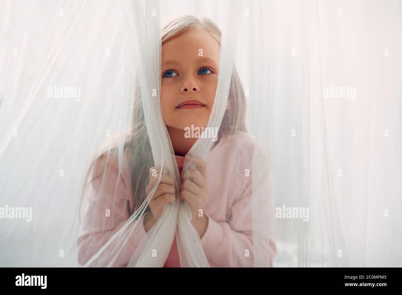 Child hiding behind curtain hi-res stock photography and images - Alamy