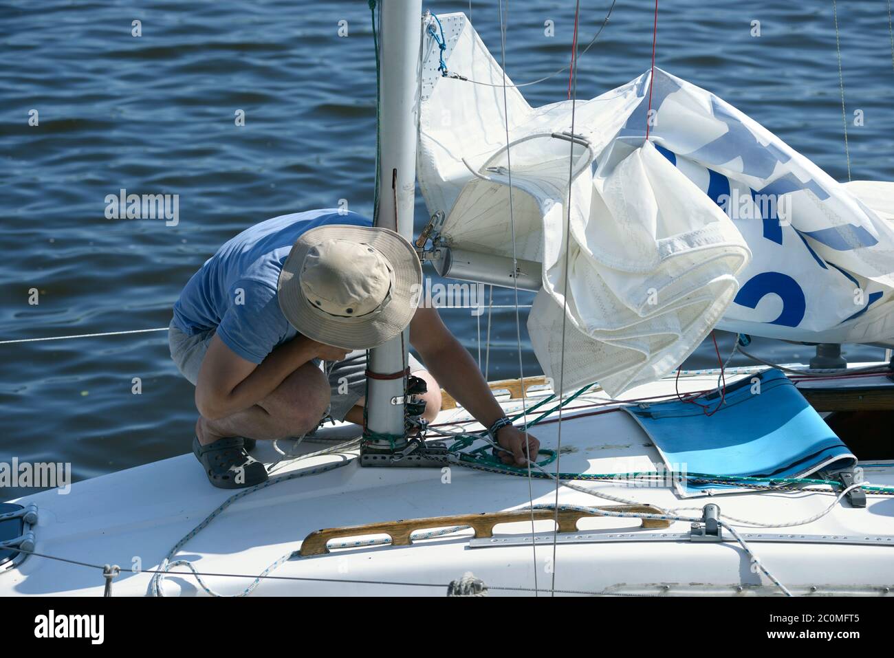 Yachtsman setting sail of yacht before race Stock Photo - Alamy