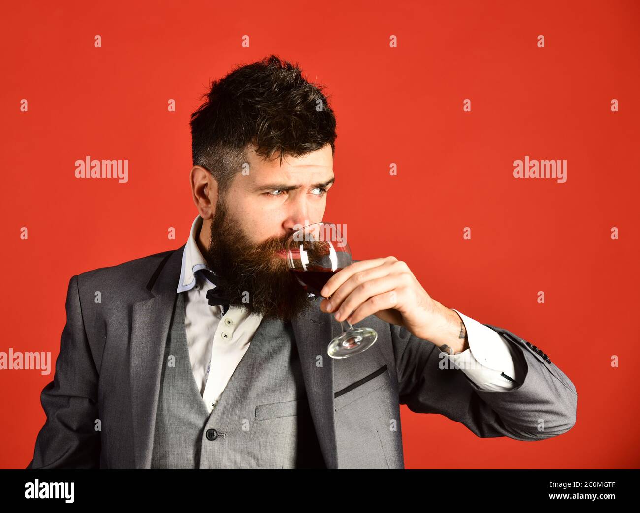 Connoisseur with serious face tasting expensive cabernet wine ...