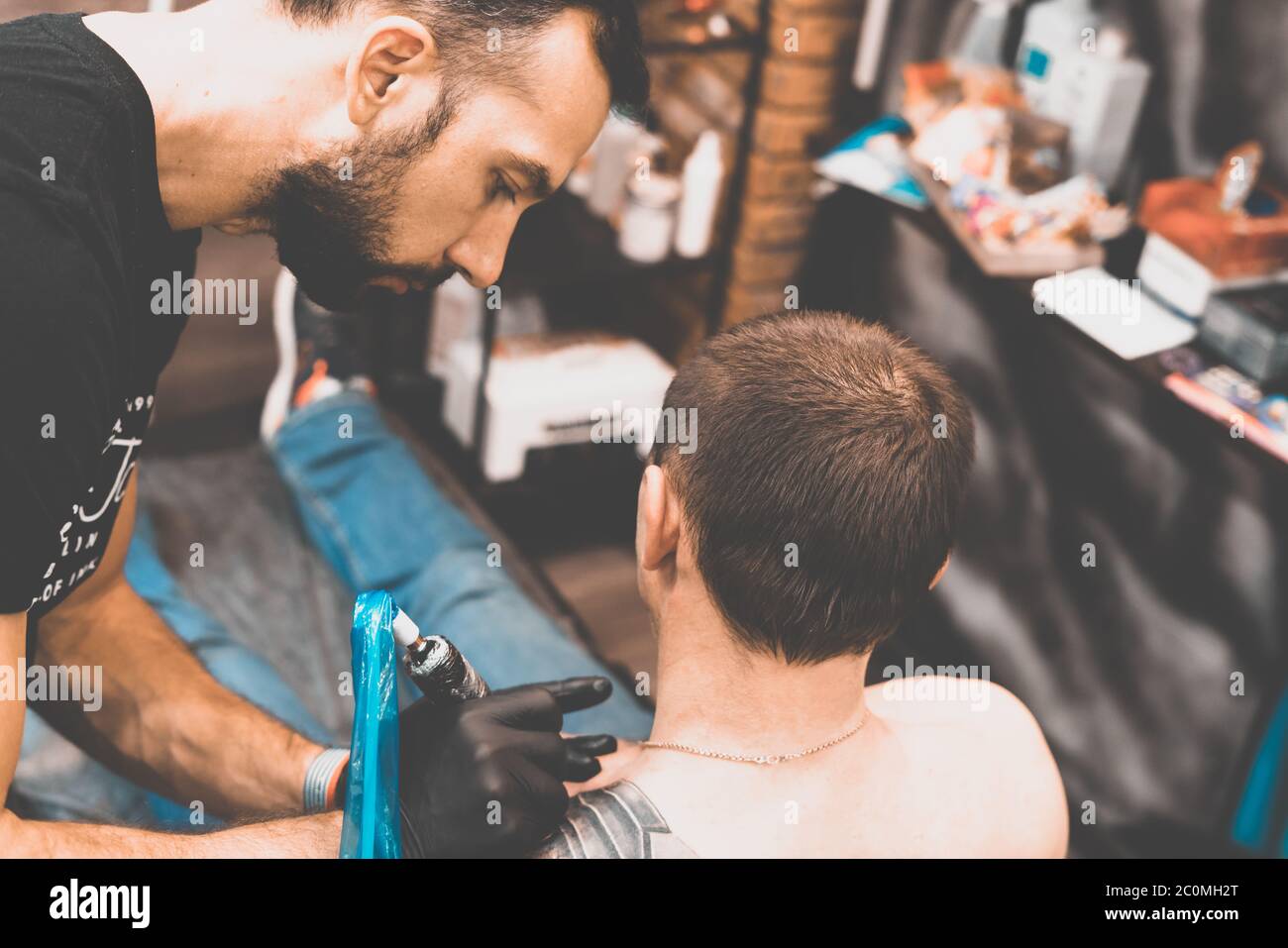 Skilled tattoo master tattooing design hi-res stock photography and ...