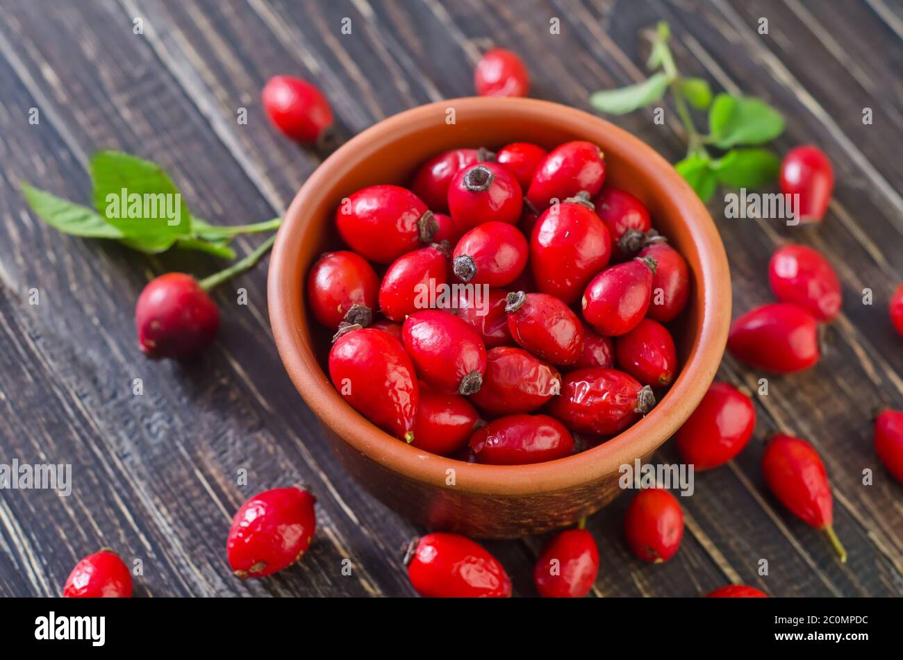 Rose hips in wooden bowl hi-res stock photography and images - Alamy